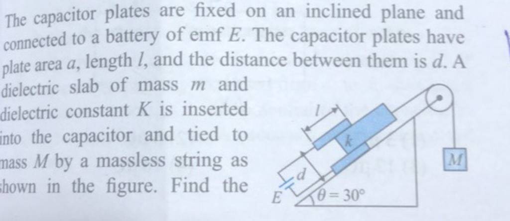 The capacitor plates are fixed on an inclined plane and connected to a ba..