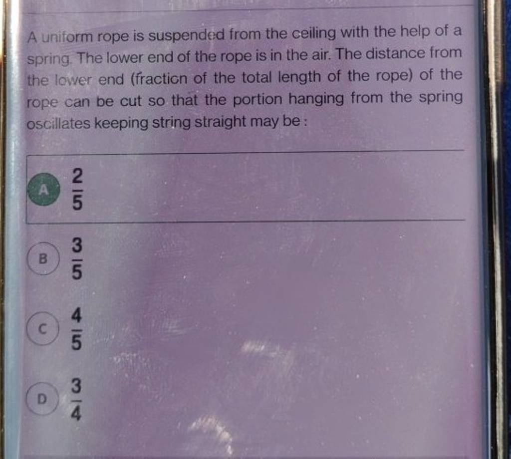 A uniform rope is suspended from the ceiling with the help of a spring. T..