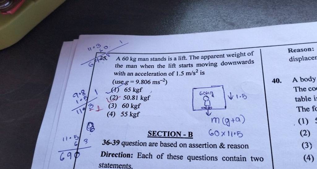A 60 kg man stands is a lift. The apparent weight of the man when the lif..
