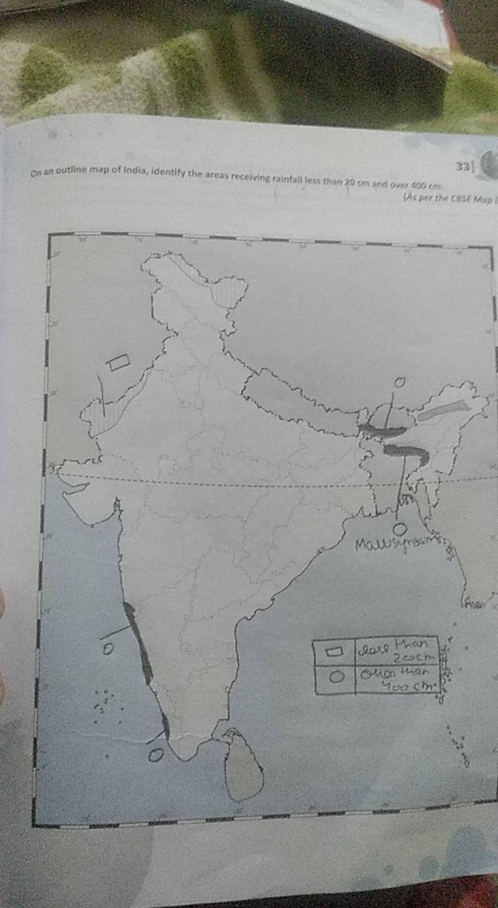 On an outline map of India, identify the areas receiving rainfall less th..