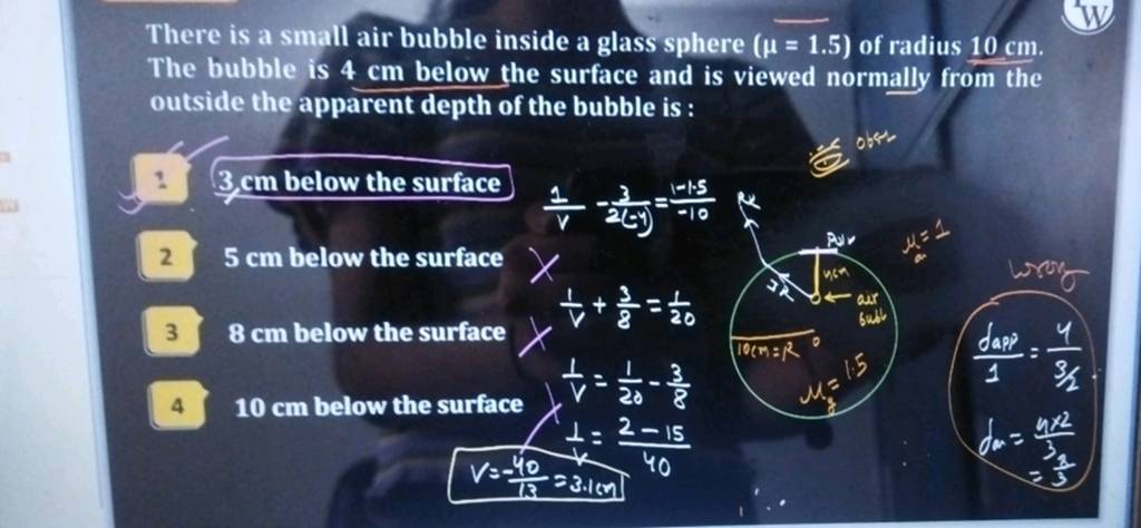 There is a small air bubble inside a glass sphere (μ=1.5) of radius 10 cm..